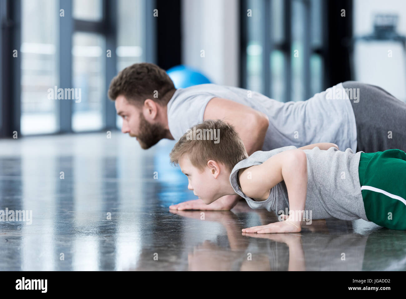 Man and boy doing push ups at fitness center Stock Photo - Alamy