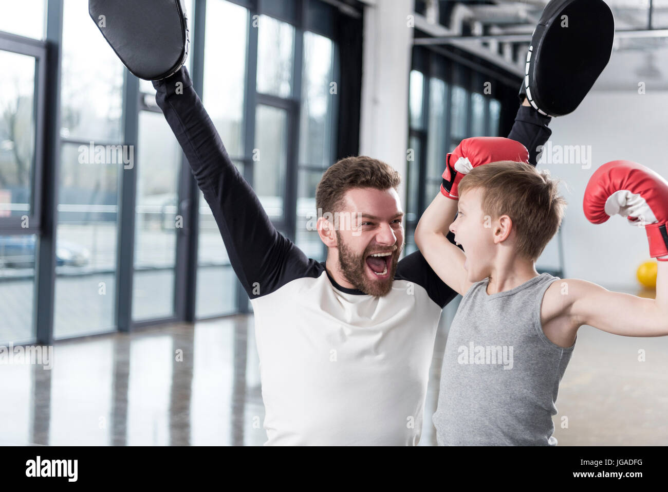 Excited young boy boxer with his coach at training Stock Photo - Alamy