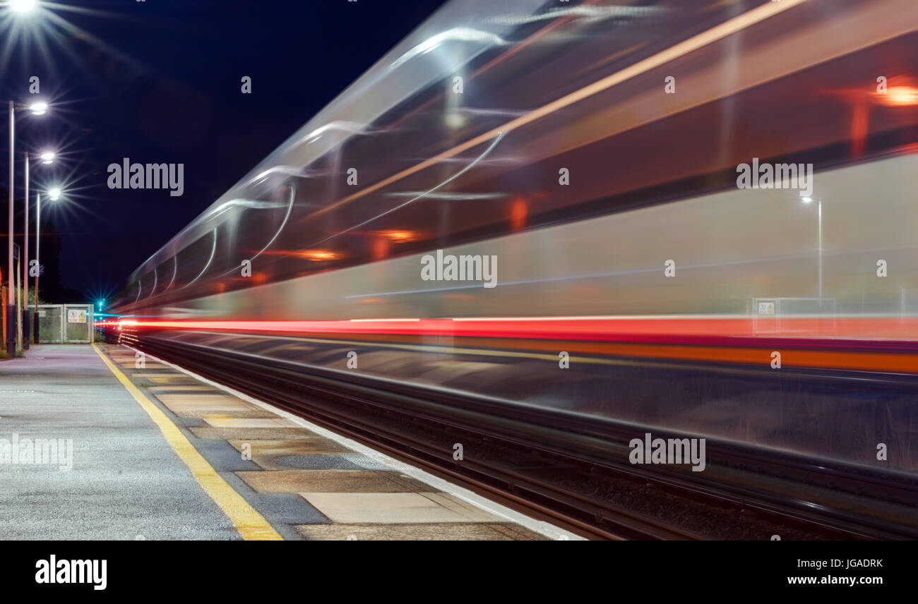 Trains speeding through a station Stock Photo - Alamy