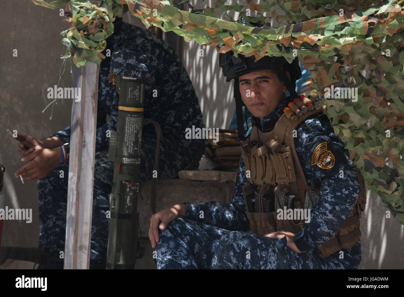 An Iraqi Federal Police member sits on the roof of a Federal Police ...