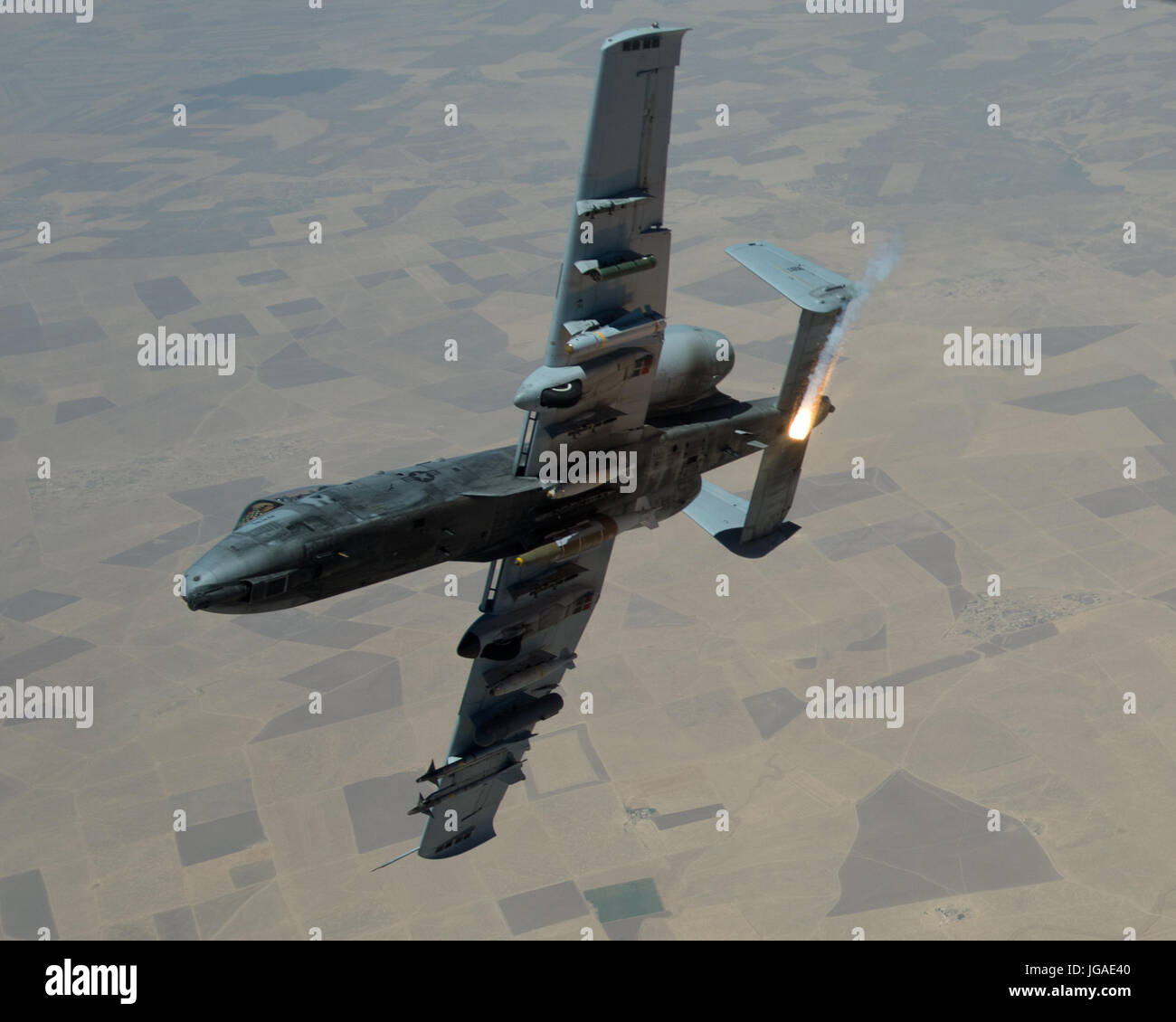 A U.S. Air Force A-10 Thunderbolt II dispenses a flare during a flight ...