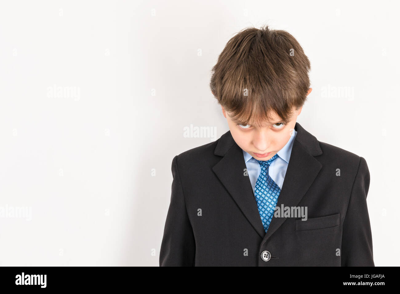 Education problems. Angry boy with head down Stock Photo - Alamy