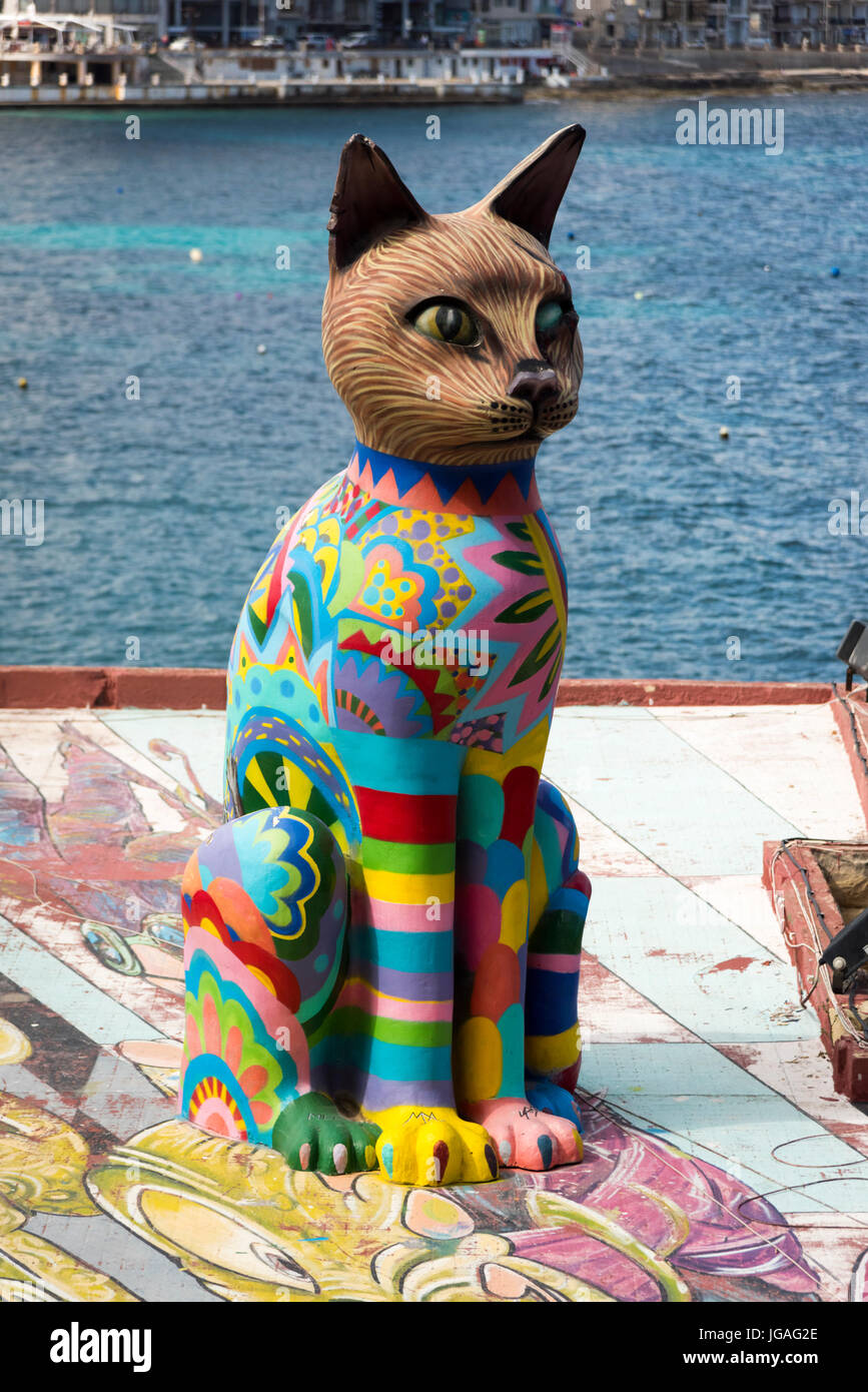 A large painted cat sculpture or artwork on the coast at Balluta Bay St ...
