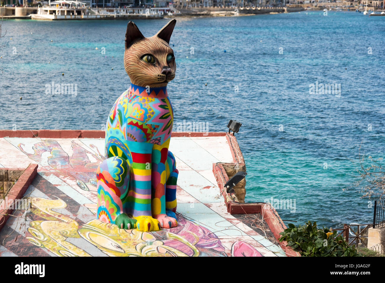 A large painted cat sculpture or artwork on the coast at Balluta Bay St ...