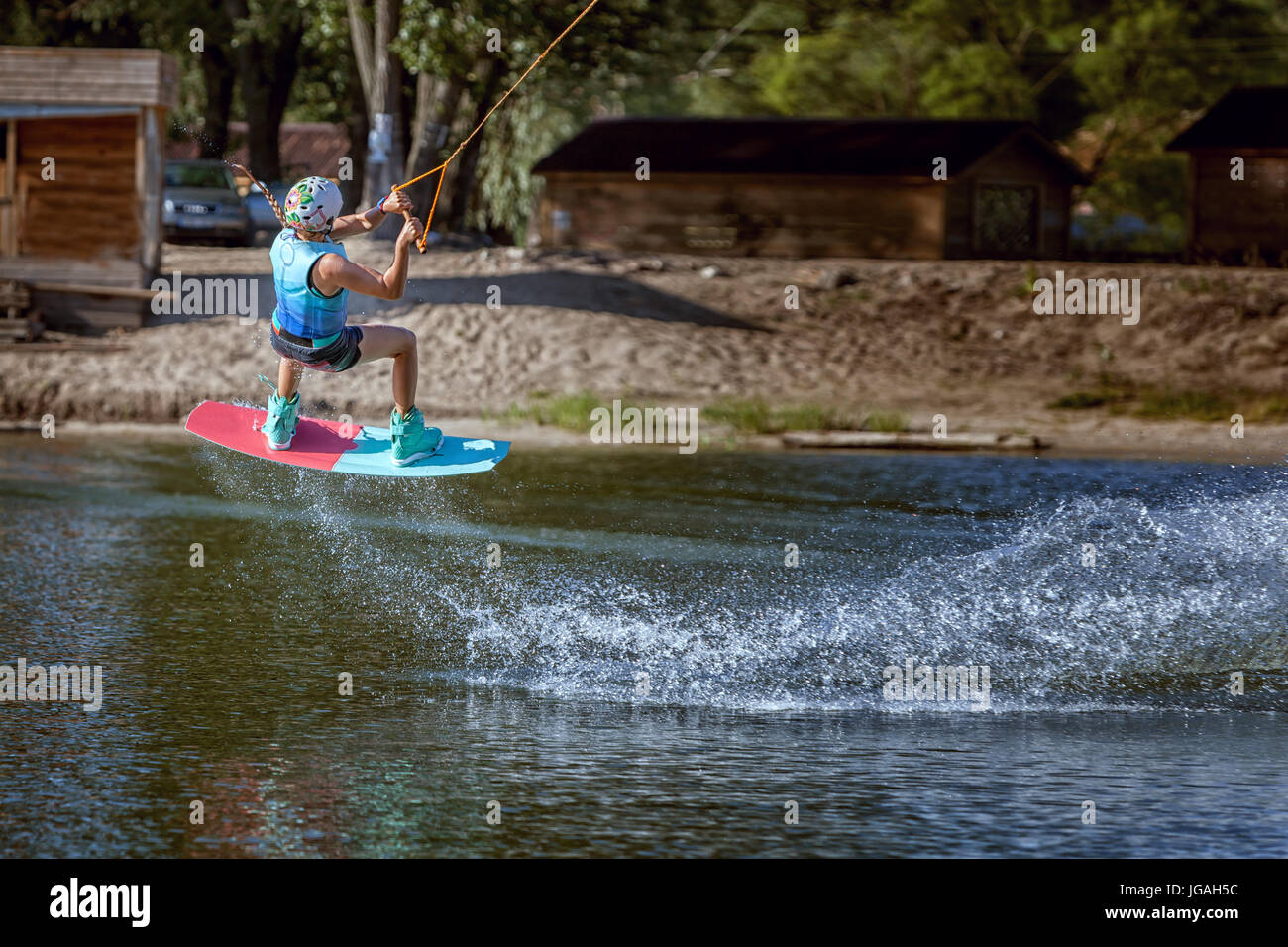 Jump over the water on a wakeboard, an extreme sport Stock Photo - Alamy