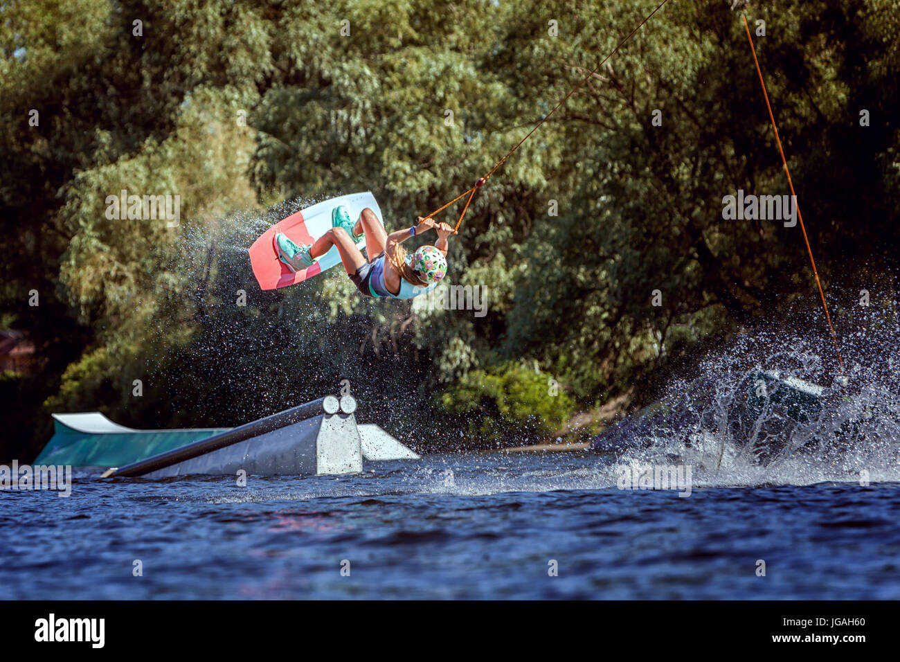 Woman is an extreme in a jump over the water. She trains before the ...