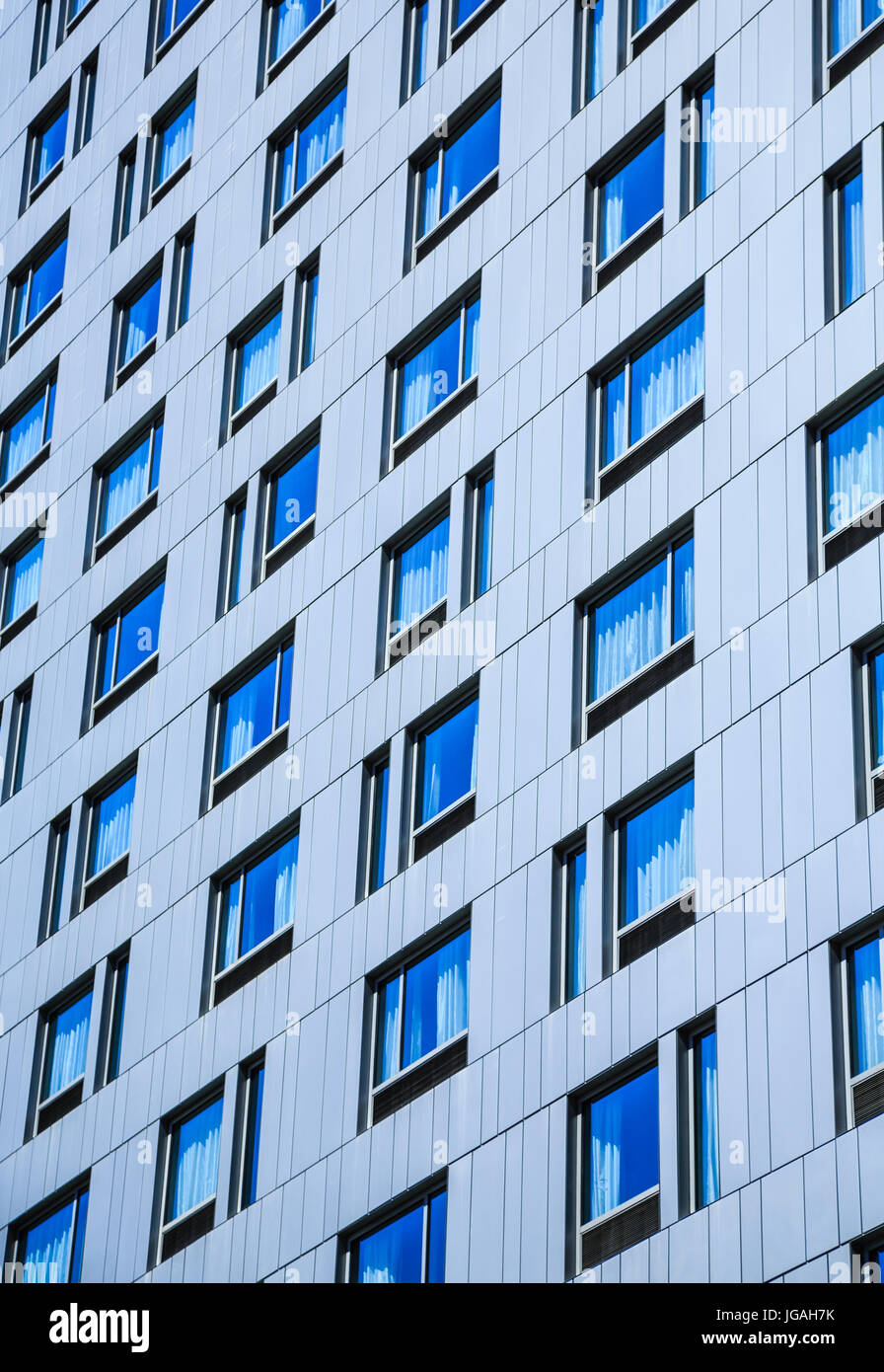 Many Blue Windows on Silver Building Stock Photo - Alamy