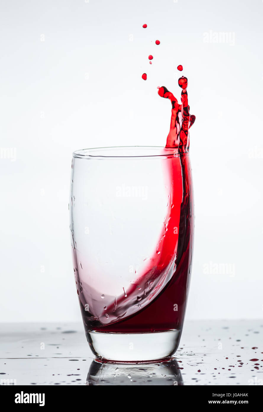 splash of drink from a glass with reflection Stock Photo - Alamy