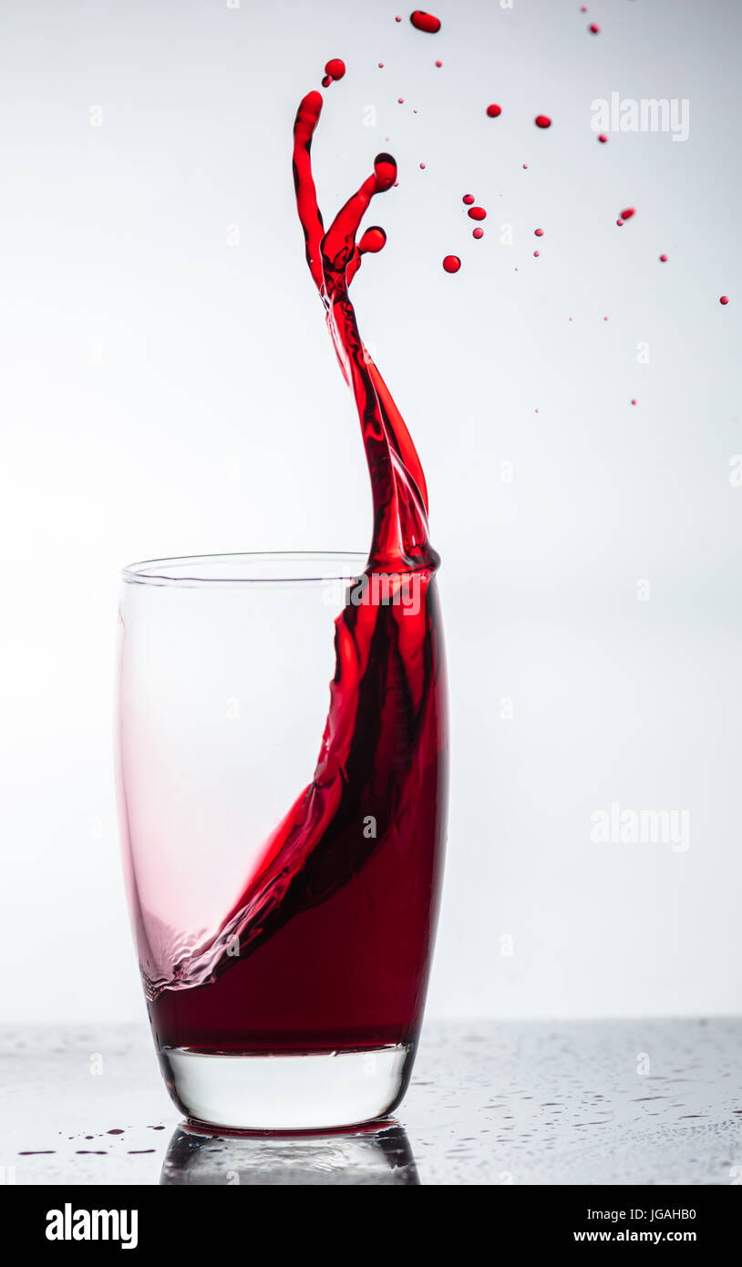 splash of drink from a glass with reflection Stock Photo - Alamy