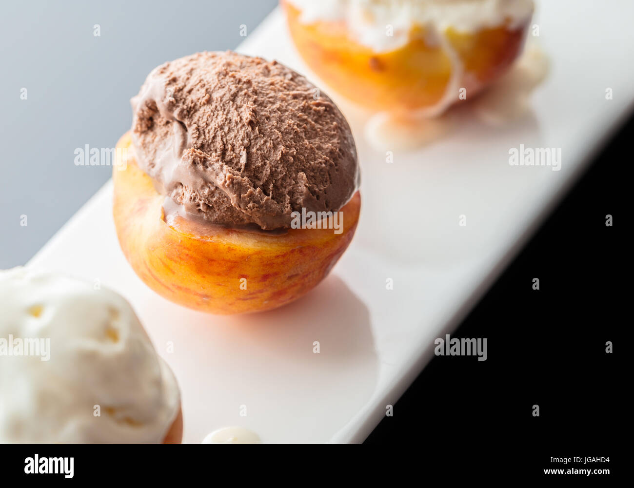 Dessert peach with ice cream ball close-up Stock Photo - Alamy