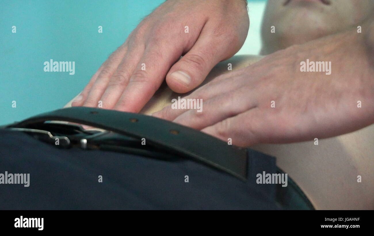 the reception at the therapist,the doctor feels the patient's abdomen ...