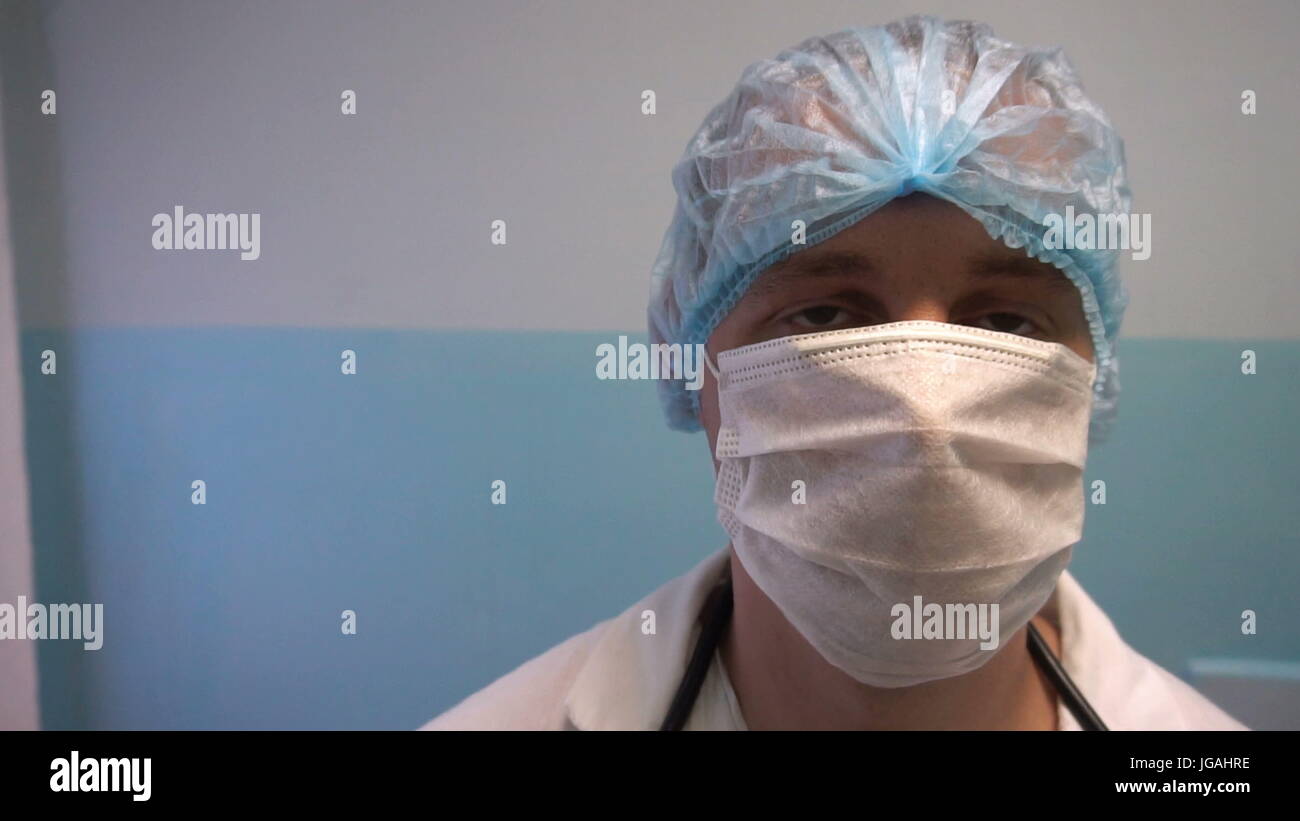 Close up of a male surgeon's face wearing surgical mask Stock Photo - Alamy
