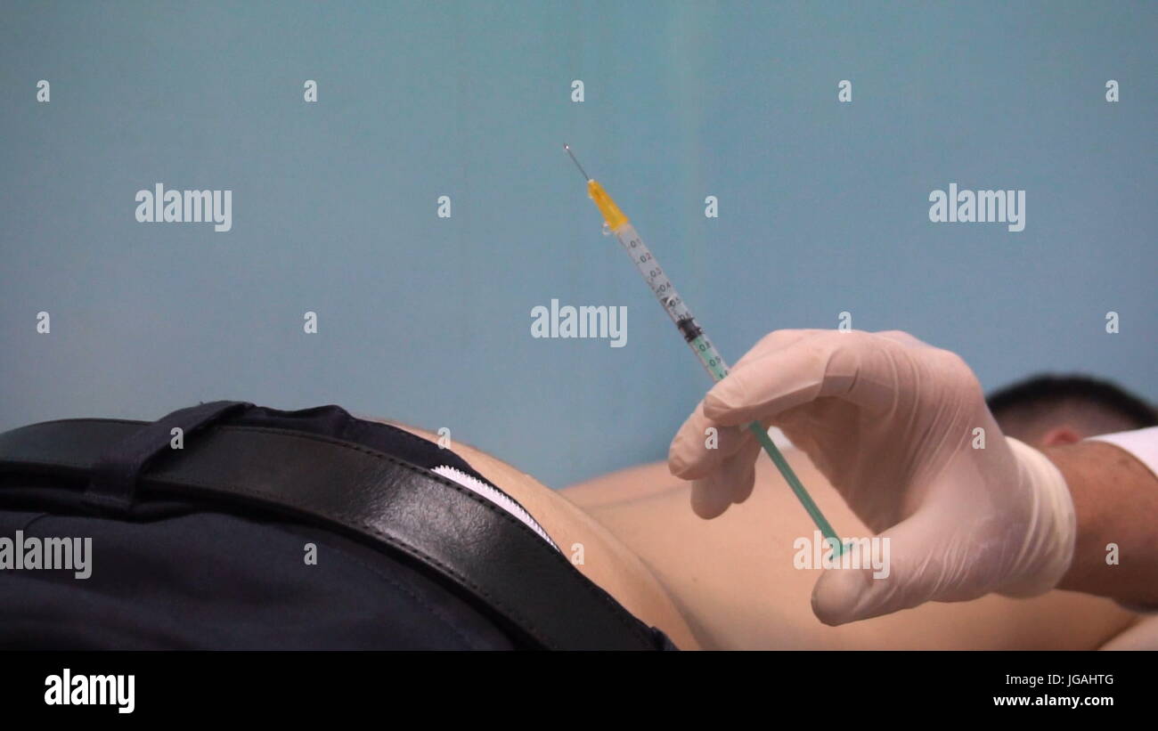 the doctor prepares the injection in the buttock Stock Photo - Alamy