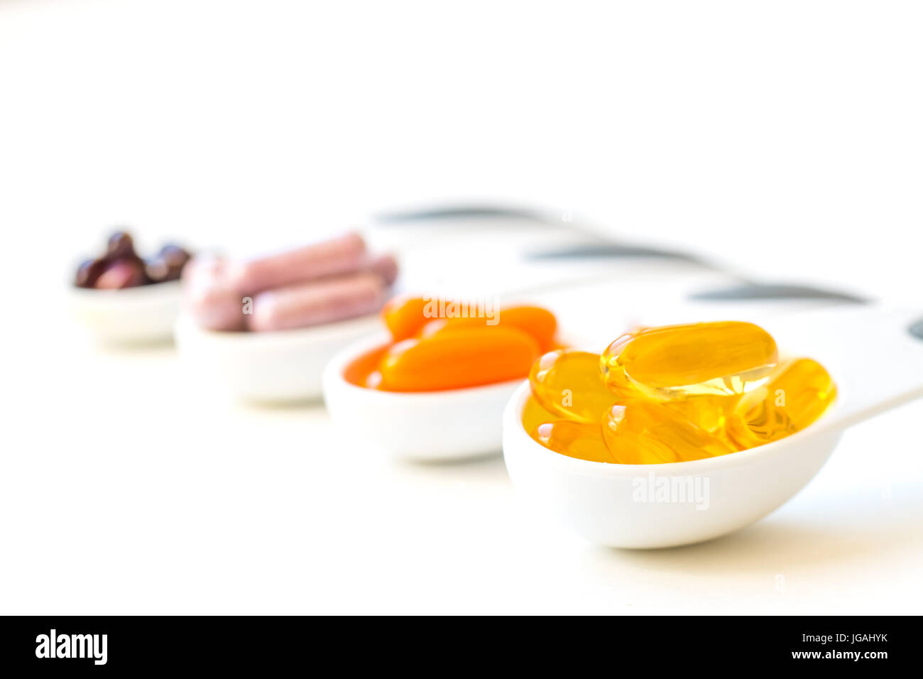 Healthy Supplement capsules in a spoons Stock Photo - Alamy