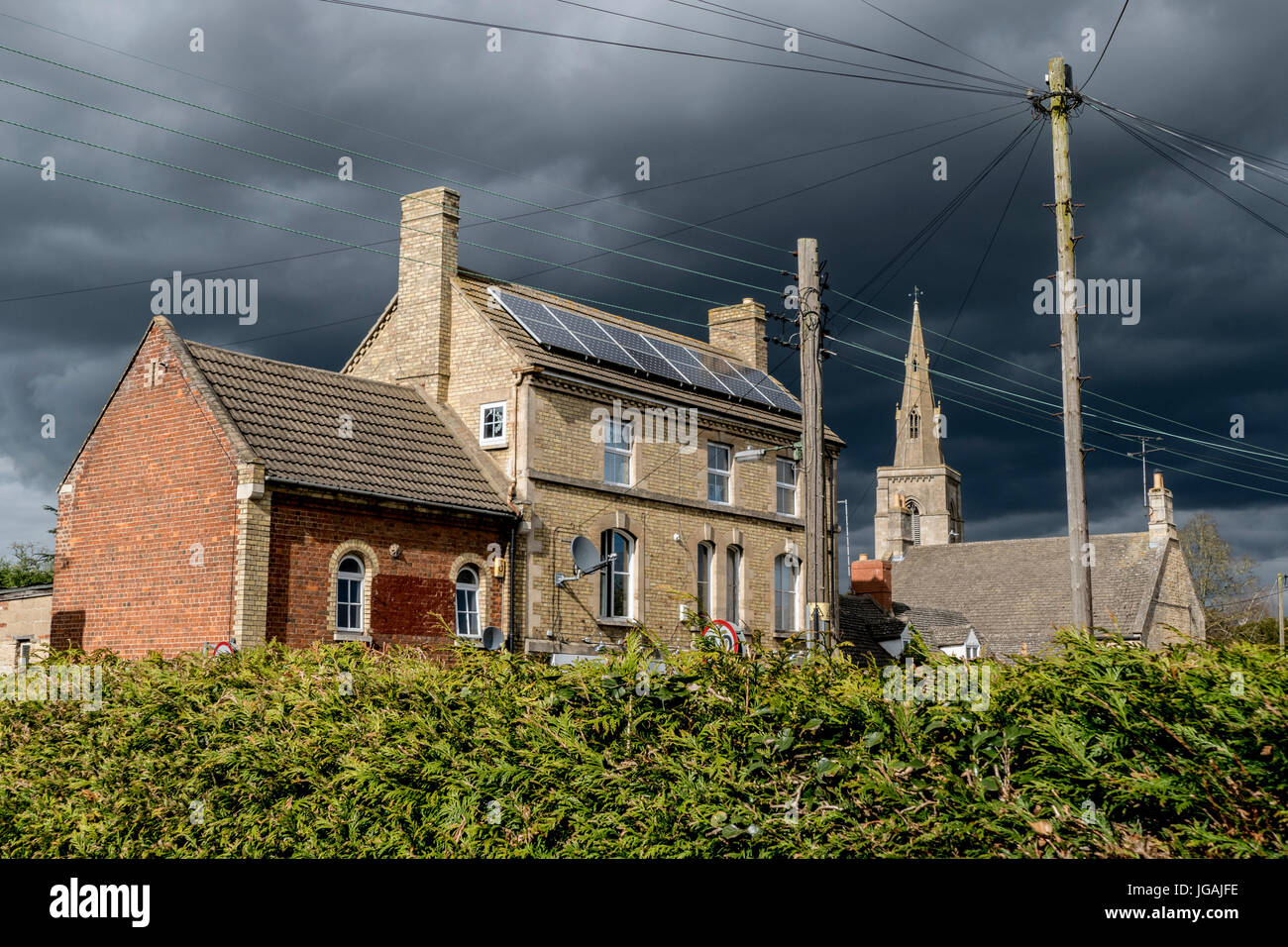 Dramatic sky with sunlight on village buildings. Langtoft, Lincolnshire ...