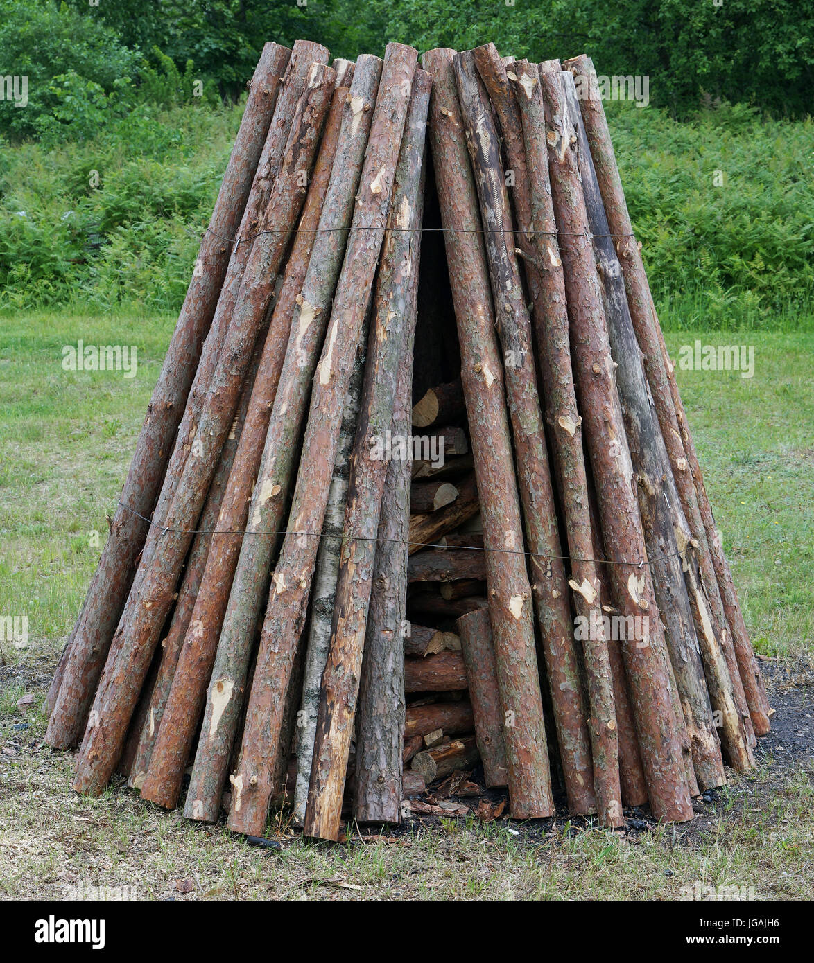 Pine logs are put in a pyramid for a traditional ritual pagan fire. The ...