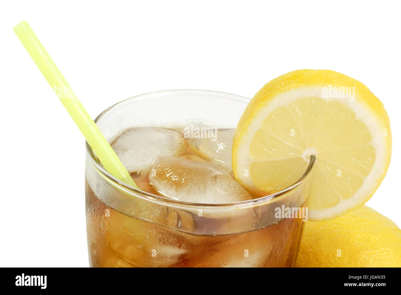 A glass full of Ice Tea with a lemon slice on bright background Stock ...