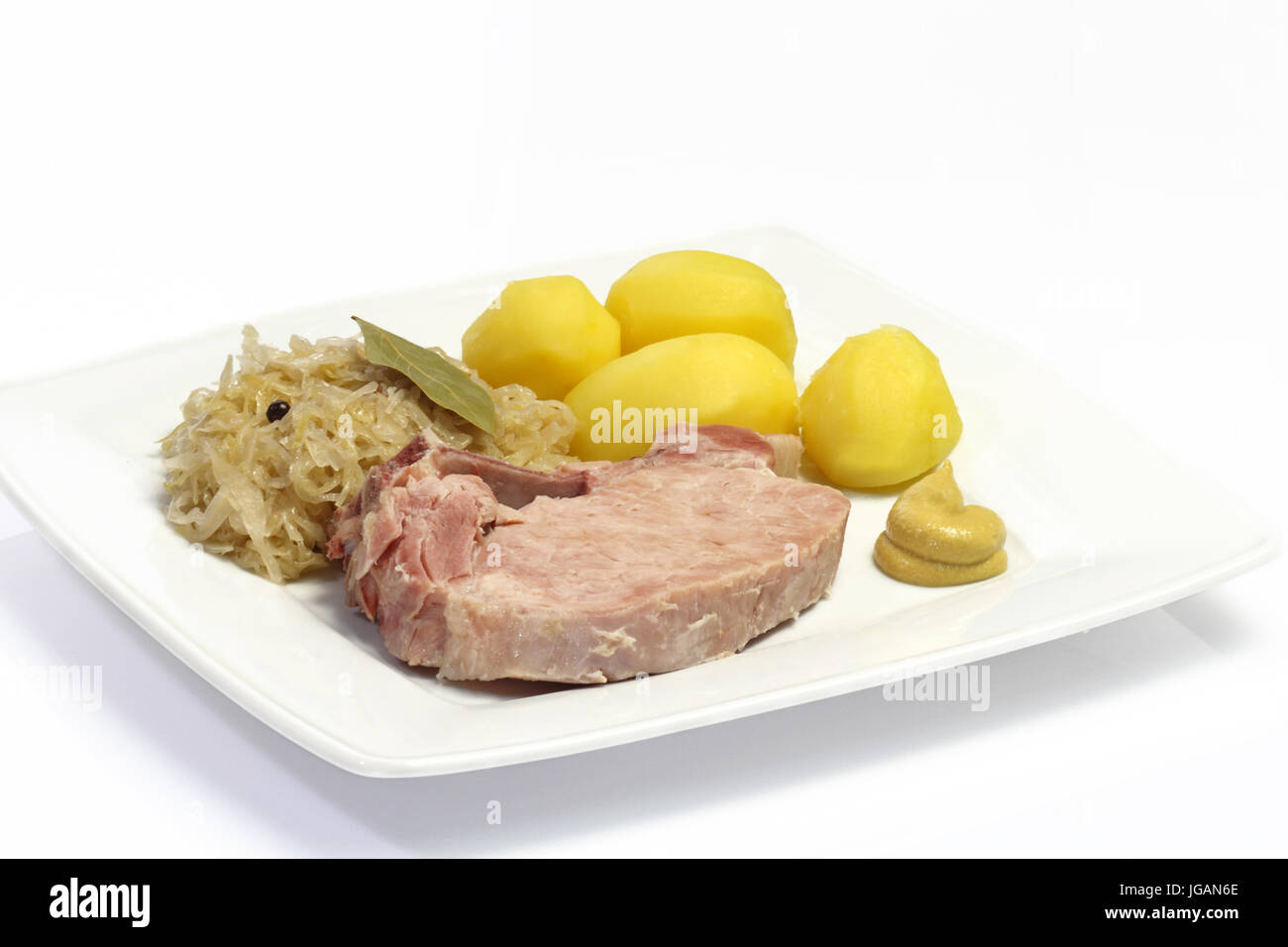 Traditional german pork meat with sauerkraut and potatoes Stock Photo ...