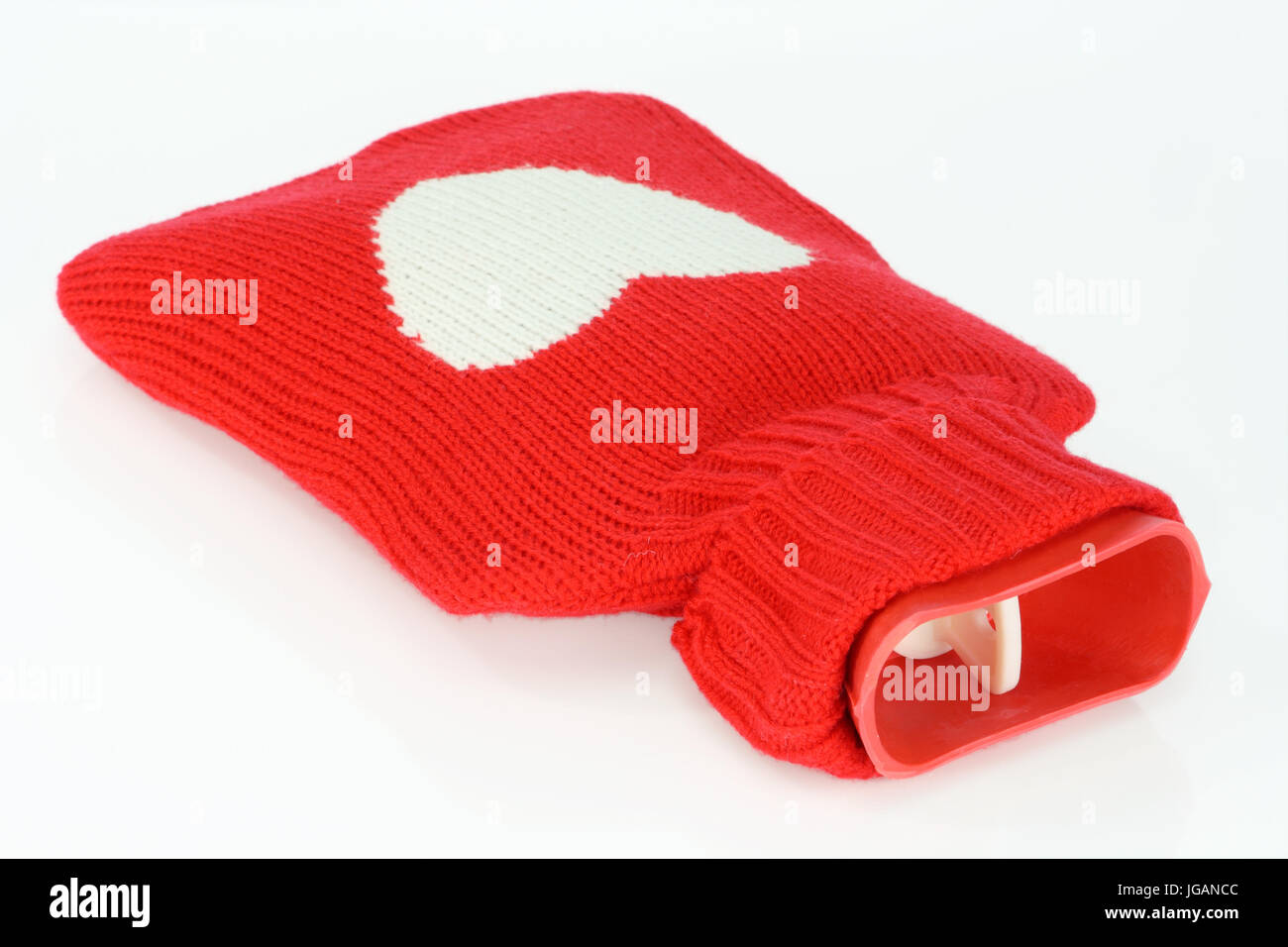 Filled red hot water bottle. White background Stock Photo - Alamy