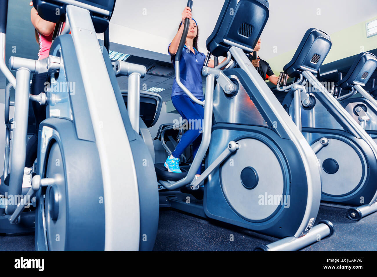 Bottom view on group of people diligently exercising on the ...
