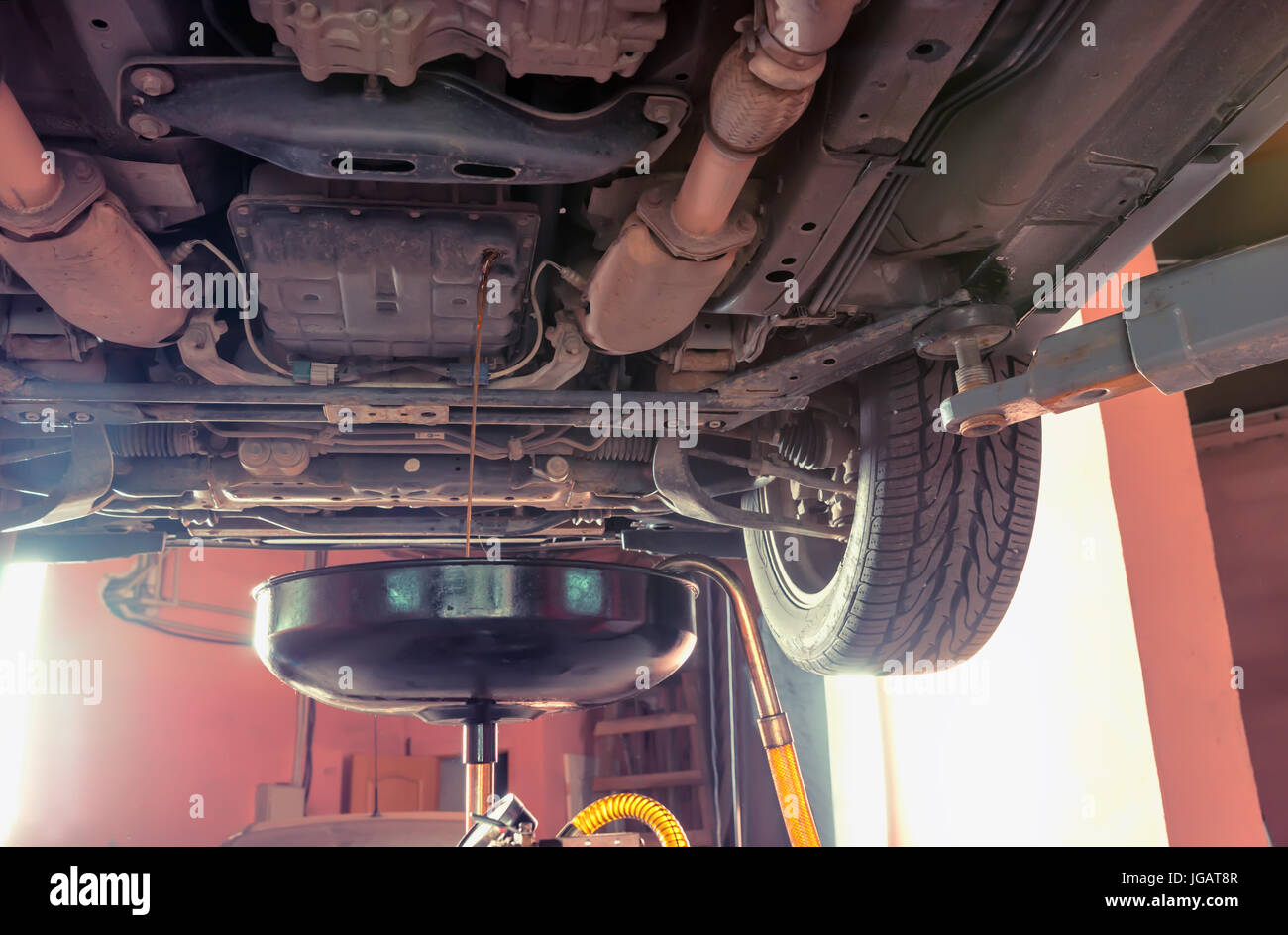 Oil flows out into equipment for changing motor oil in automobile ...