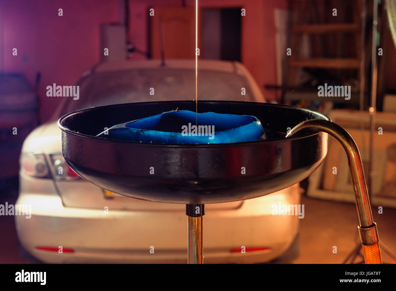 Close up of oil jet flows out into equipment for changing motor oil in ...
