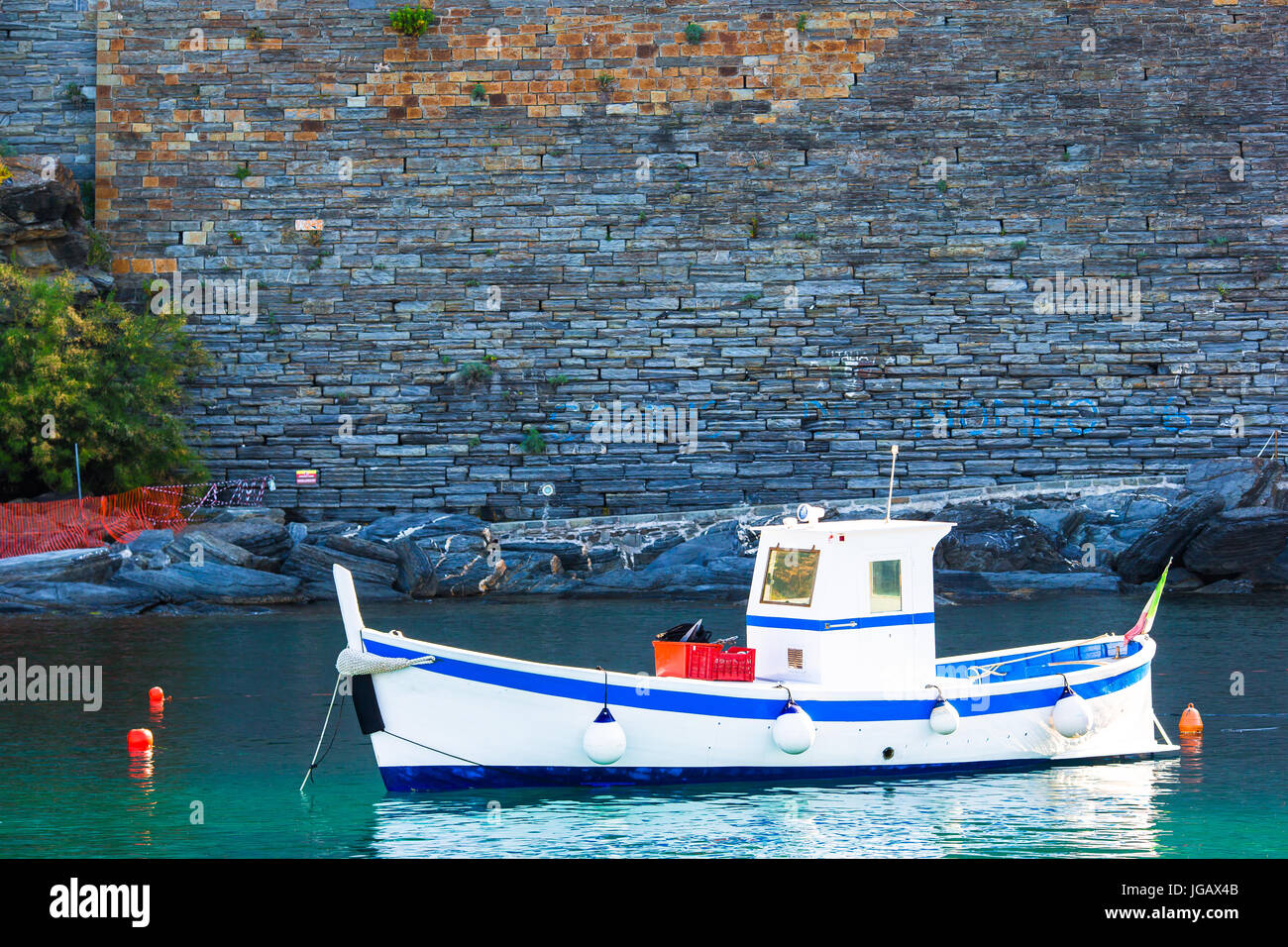 Small boat in the bay in an old small village in the Cinque Terre Stock ...