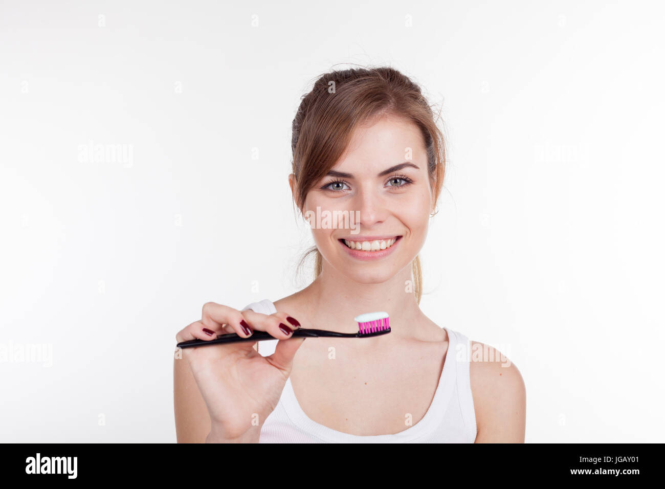 girl holding a toothbrush smiles Stock Photo - Alamy