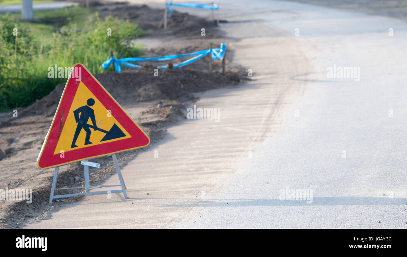 triangle road sign work in progress on a street under reconstruction ...