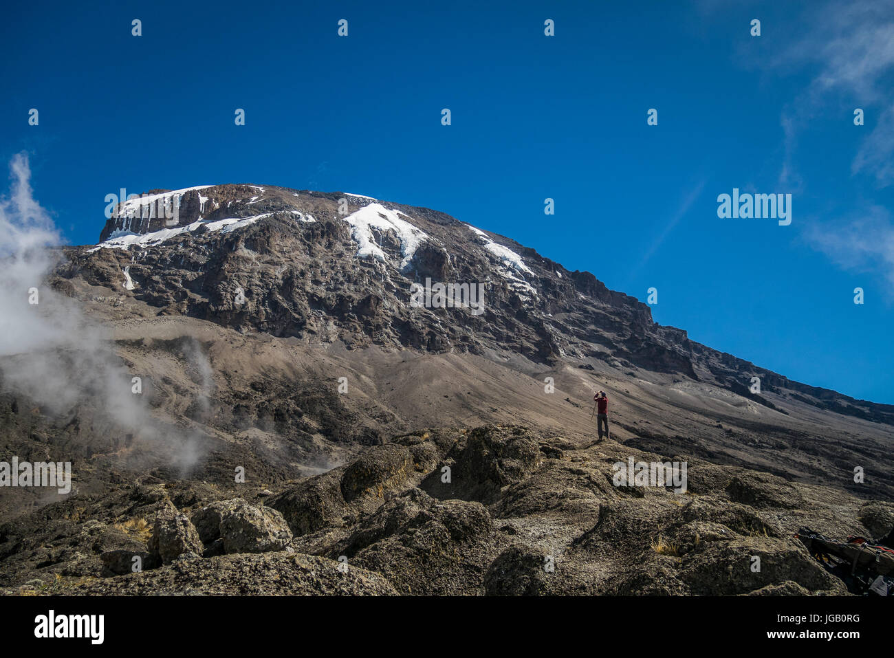 Man takes photo of Kibo peak in Mount Kilimanjaro, Tanzania, Africa ...
