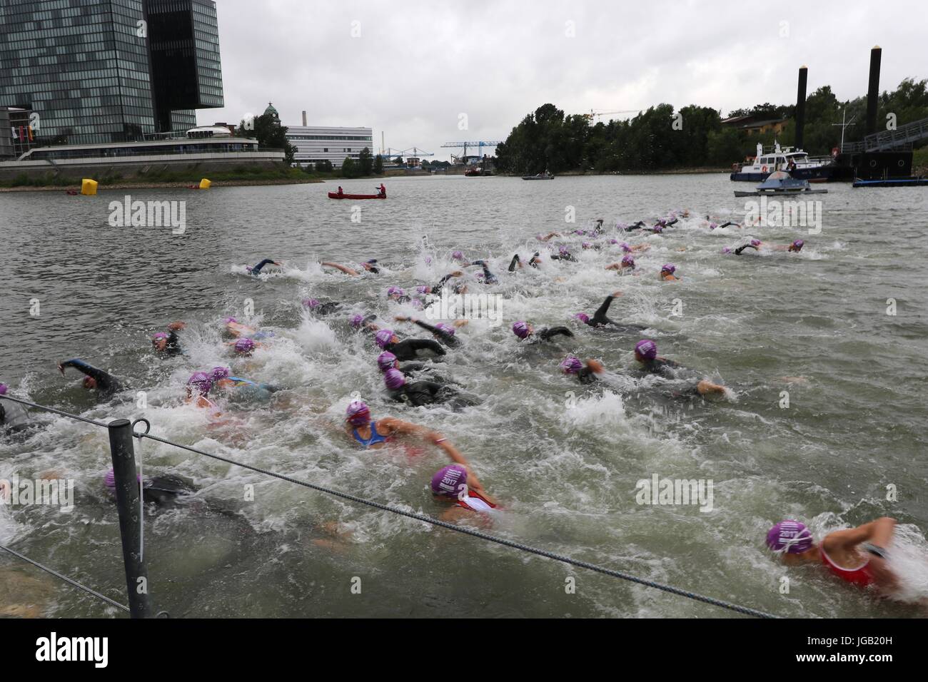 a large group of swimmers in action making lots of splashing at the ...