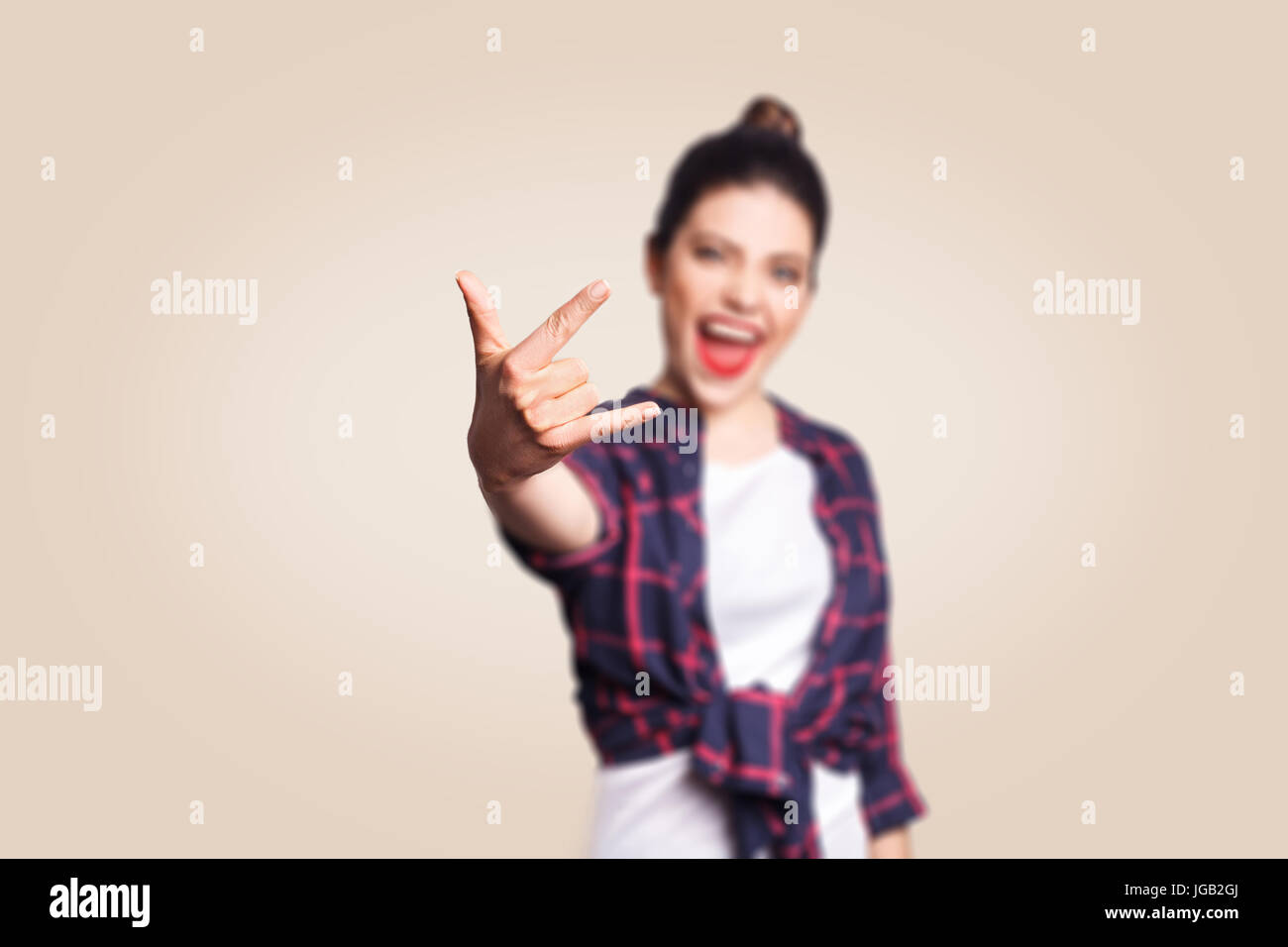 Rock sign. Happy funny toothy smiley young woman showing Rock sign with ...