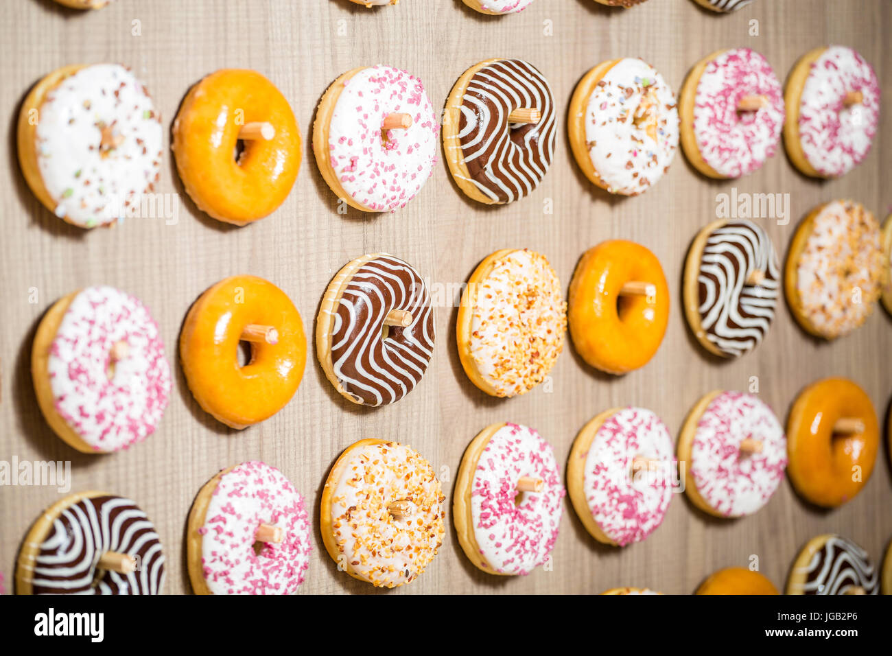 Delicious , colorful doughnuts in a row Stock Photo - Alamy