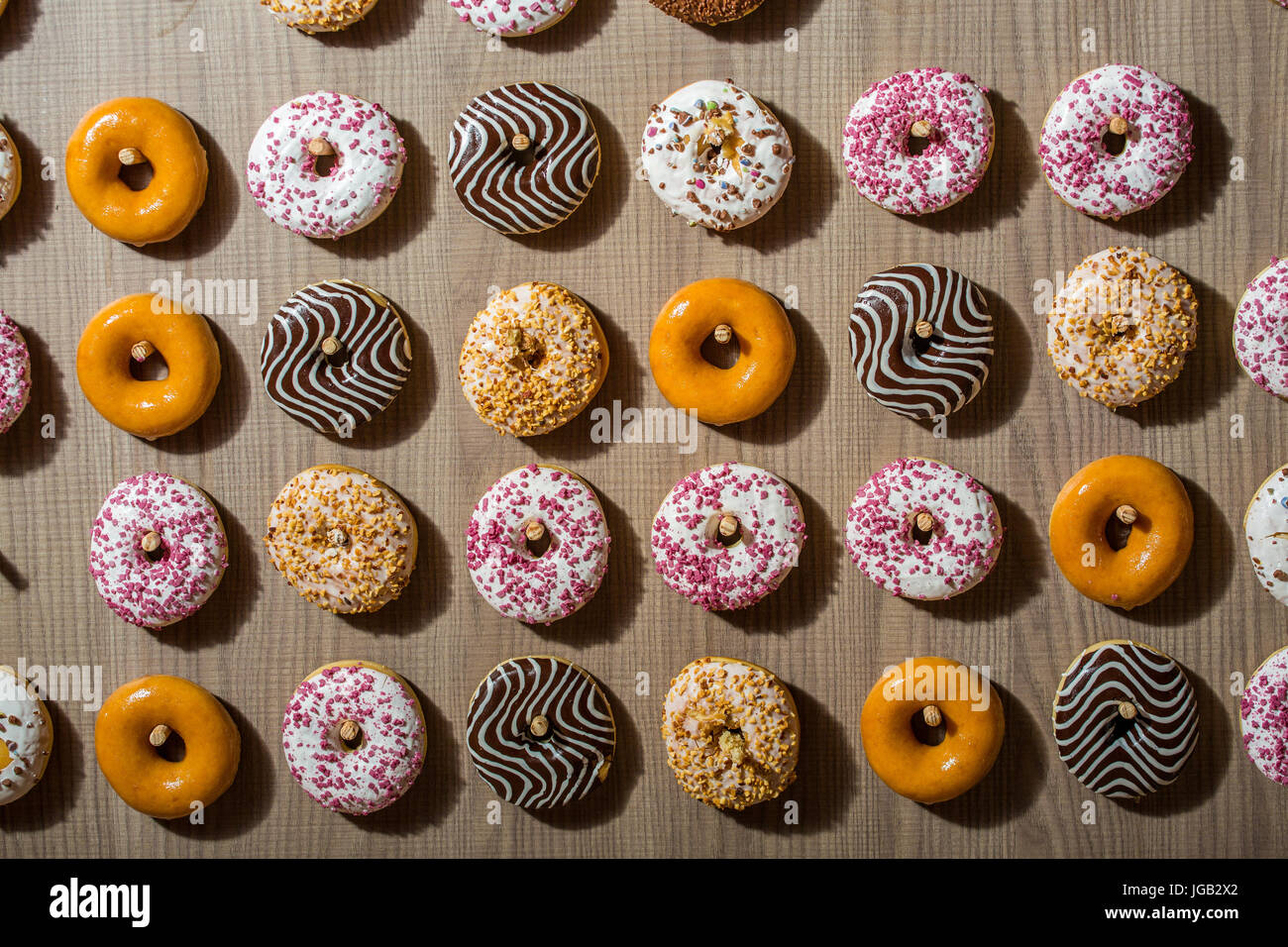 Delicious , colorful doughnuts in a row Stock Photo - Alamy
