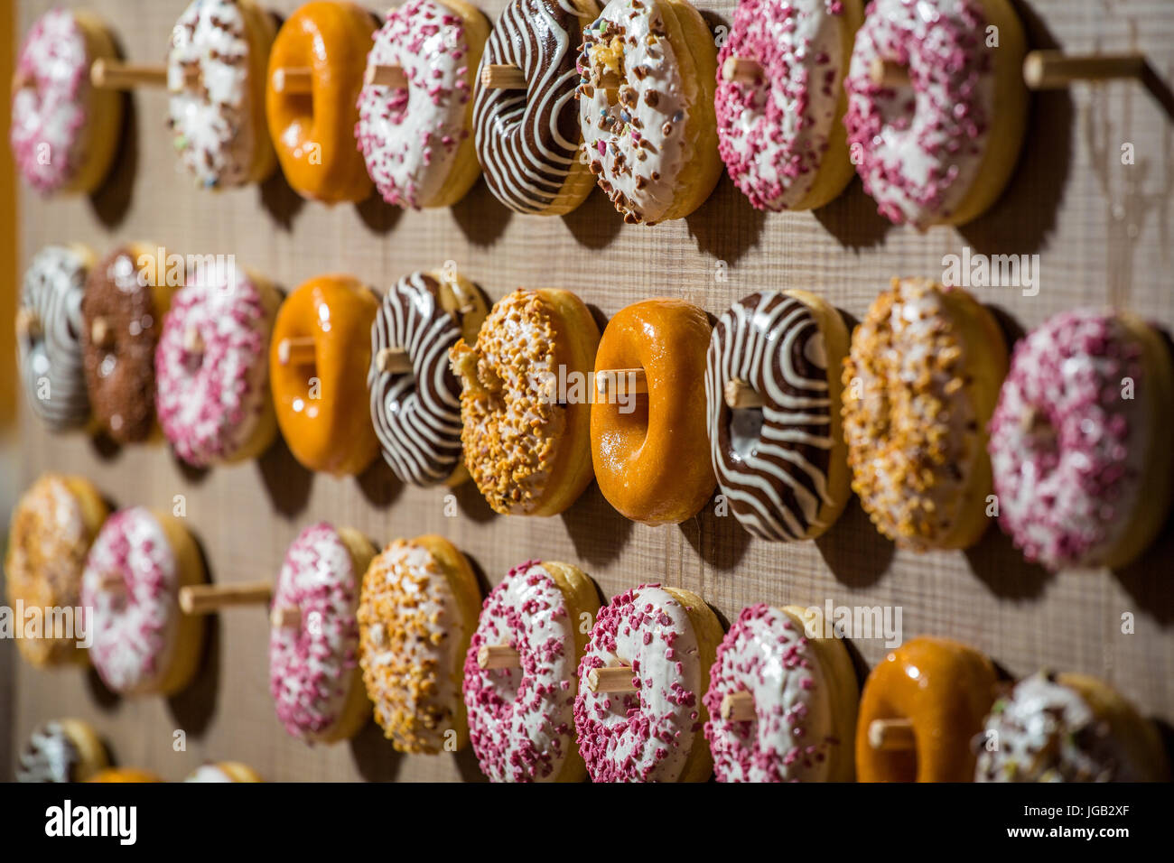 Delicious , colorful doughnuts in a row Stock Photo - Alamy