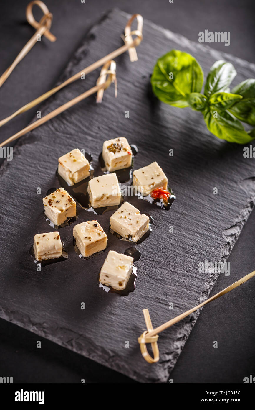 Cheese with spices on black slate Stock Photo - Alamy