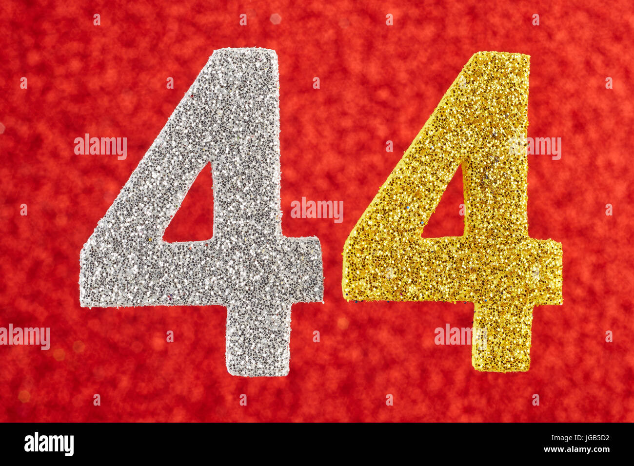 Number forty-four silver yellow color over a red background ...
