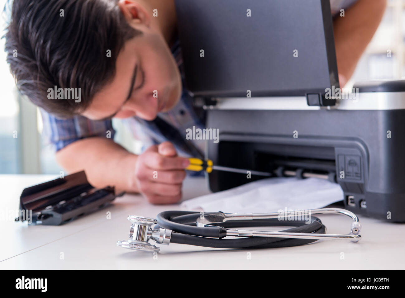 Repairman repairing broken color printer Stock Photo - Alamy