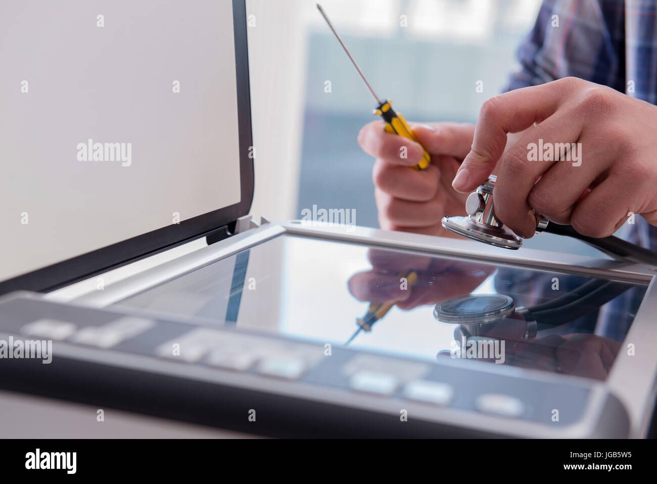 Repairman repairing broken color printer Stock Photo - Alamy