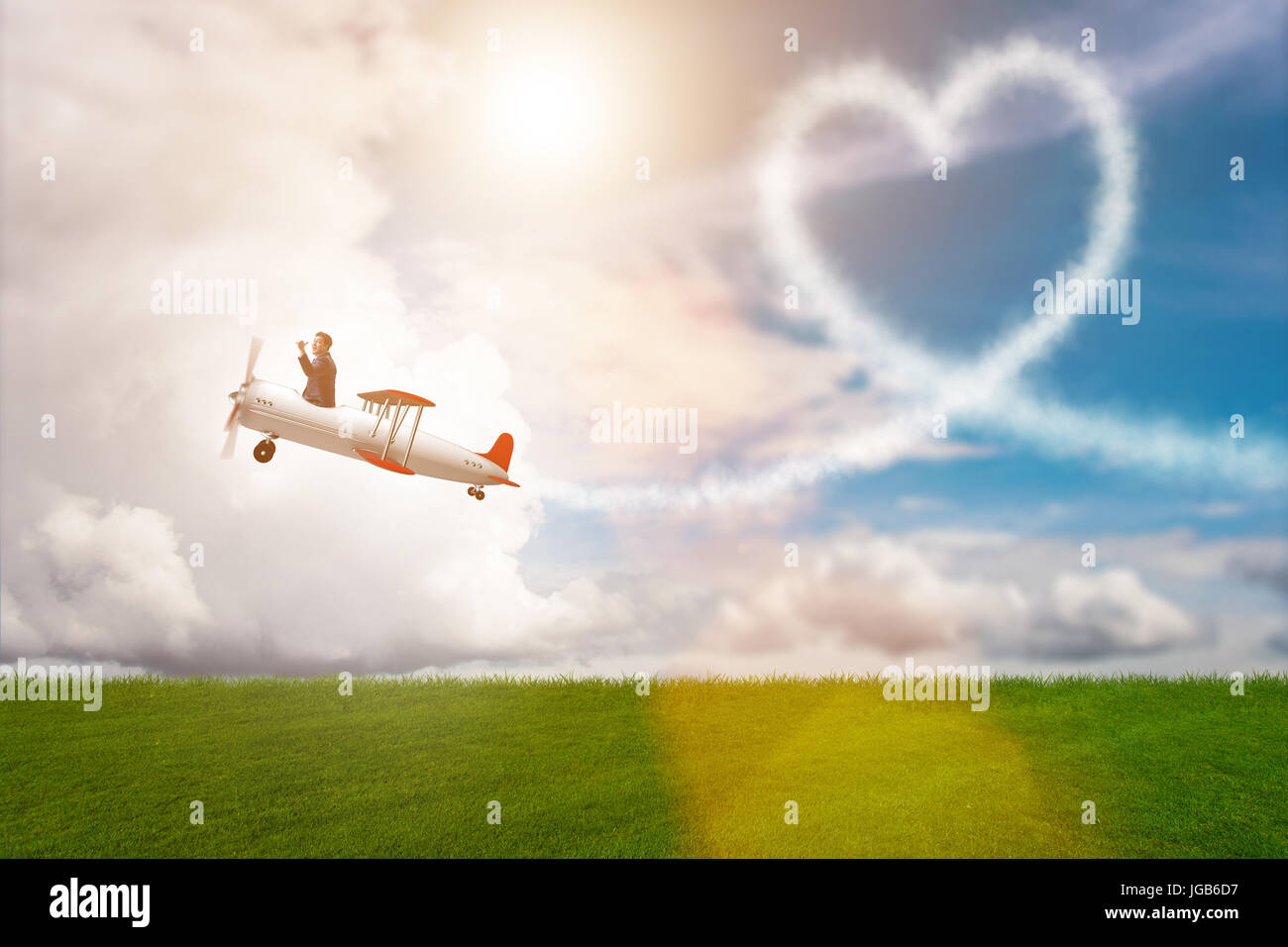 Man flying airplane and making heart shape Stock Photo - Alamy