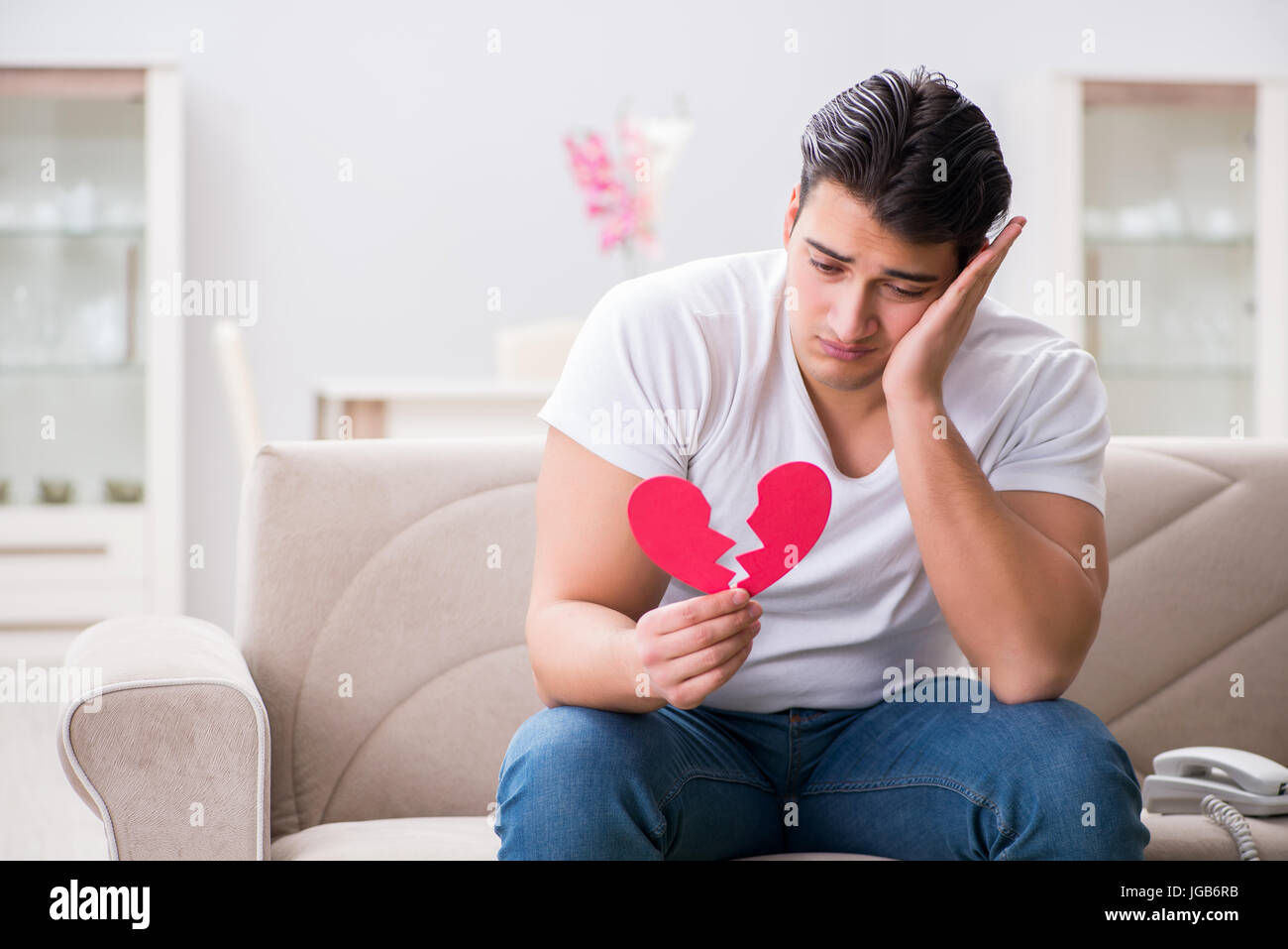 Young man in sad saint valentine concept Stock Photo - Alamy