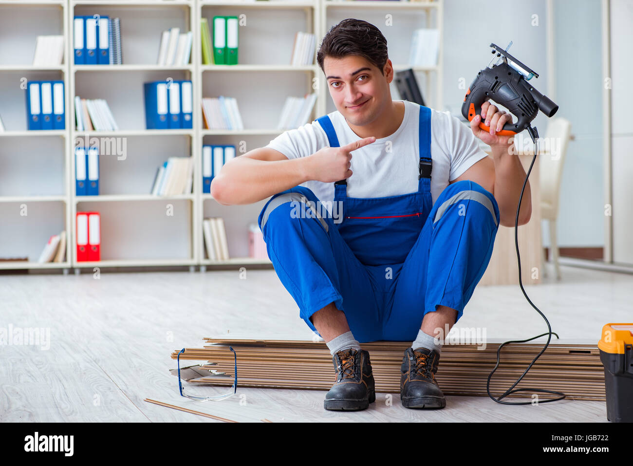 Young worker working on floor laminate tiles Stock Photo - Alamy