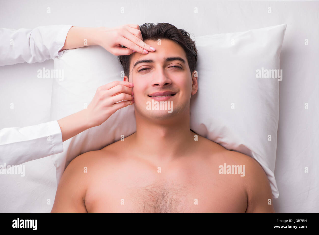 Handsome man in spa massage concept Stock Photo - Alamy