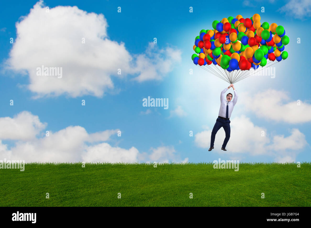 Businessman flying balloons on bright day Stock Photo - Alamy