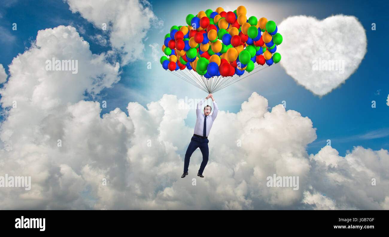 Man flying balloons in romantic concept Stock Photo - Alamy