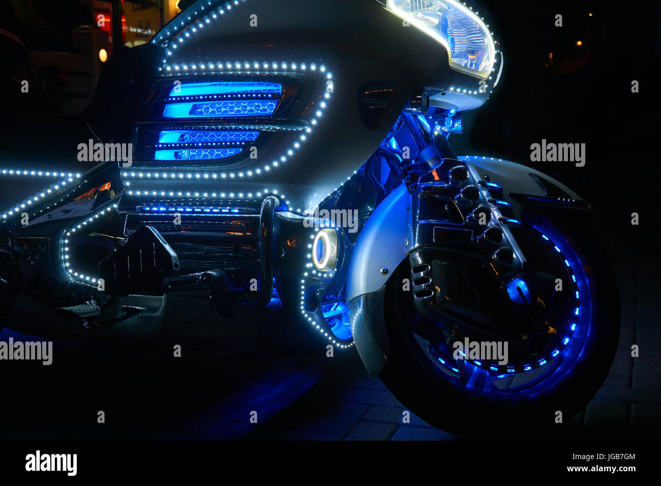 Side view of the motorcycle with led lights in the street at night in ...