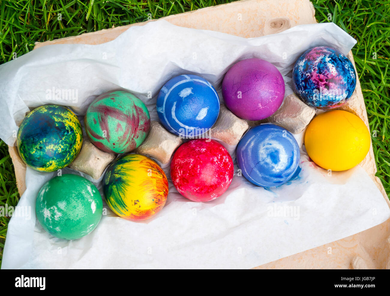 Many colorful dyed easter eggs in a box. Arty colours, handmade ...