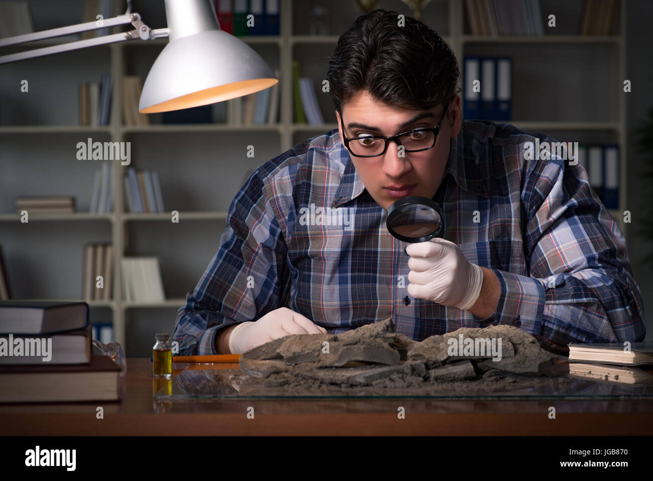 Archeologist working late night in office Stock Photo - Alamy