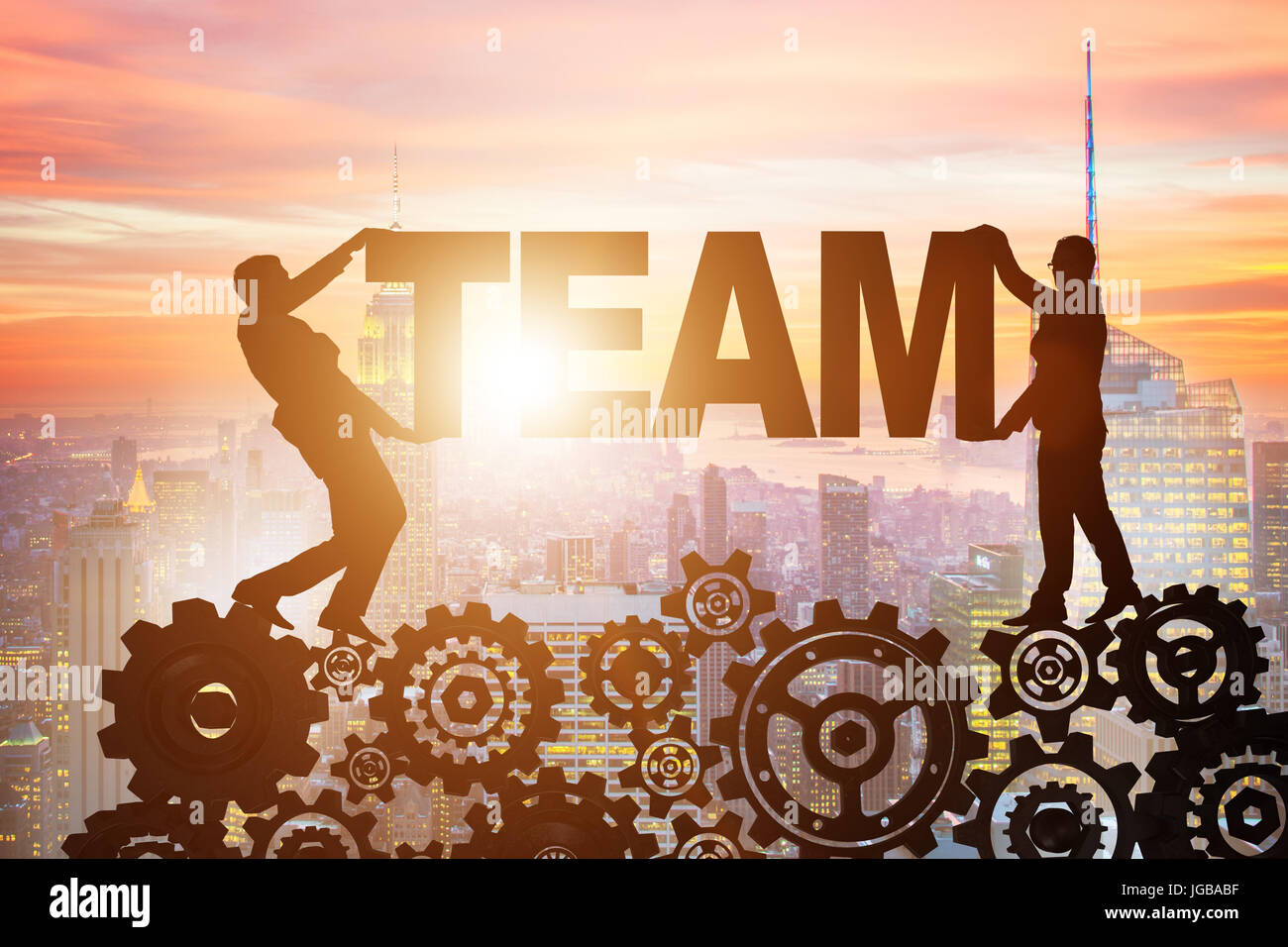 Businessmen holding word team in teamwork concept Stock Photo - Alamy