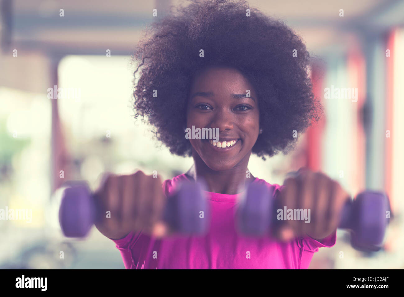 happy healthy african american woman working out in a crossfit gym on ...